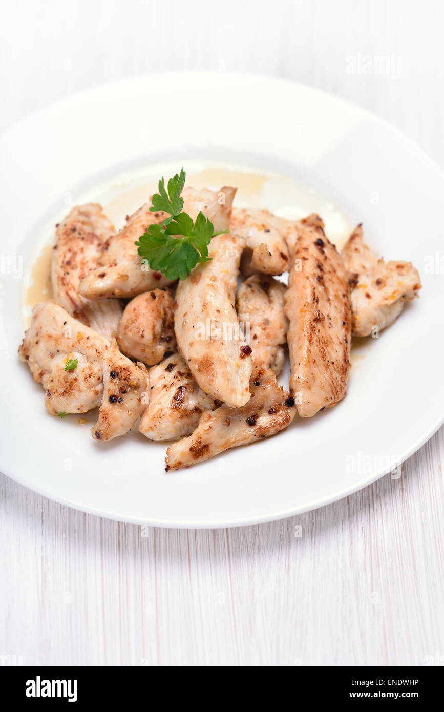 Grilled chicken meat sliced on white plate, close up view Stock Photo ...