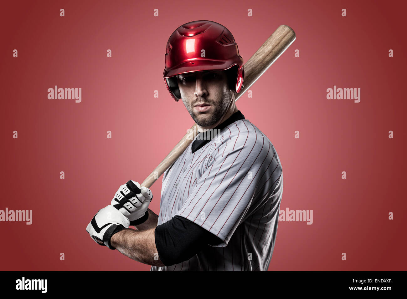 Baseball Player on a Red Uniform on red background Stock Photo - Alamy