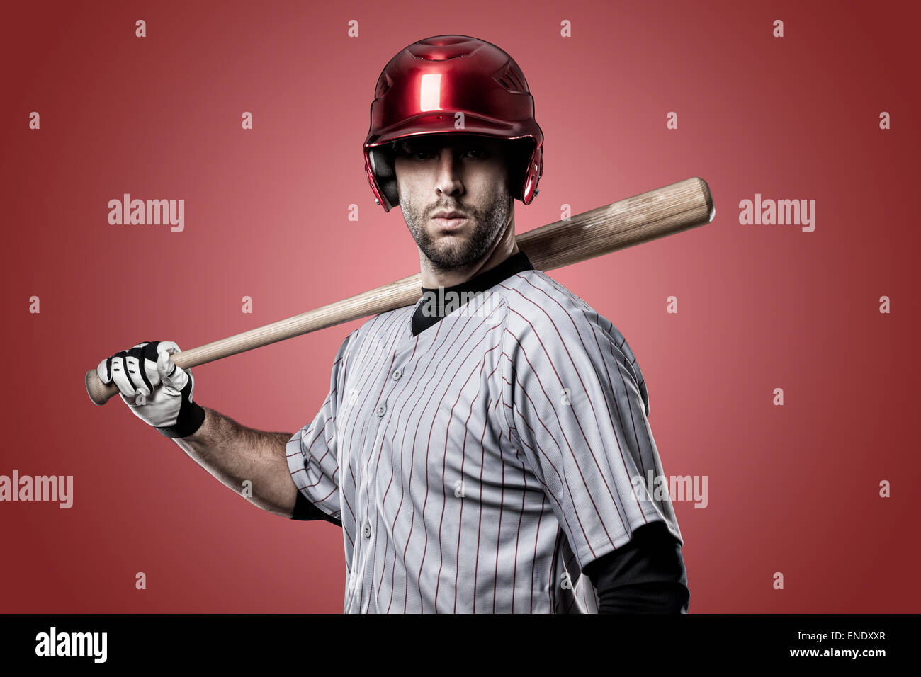 Baseball Player on a Red Uniform on red background Stock Photo - Alamy