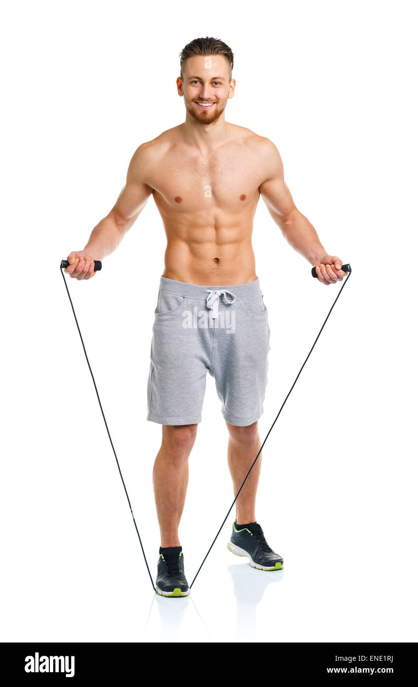 Athletic attractive man jumping on a rope on the white background Stock ...