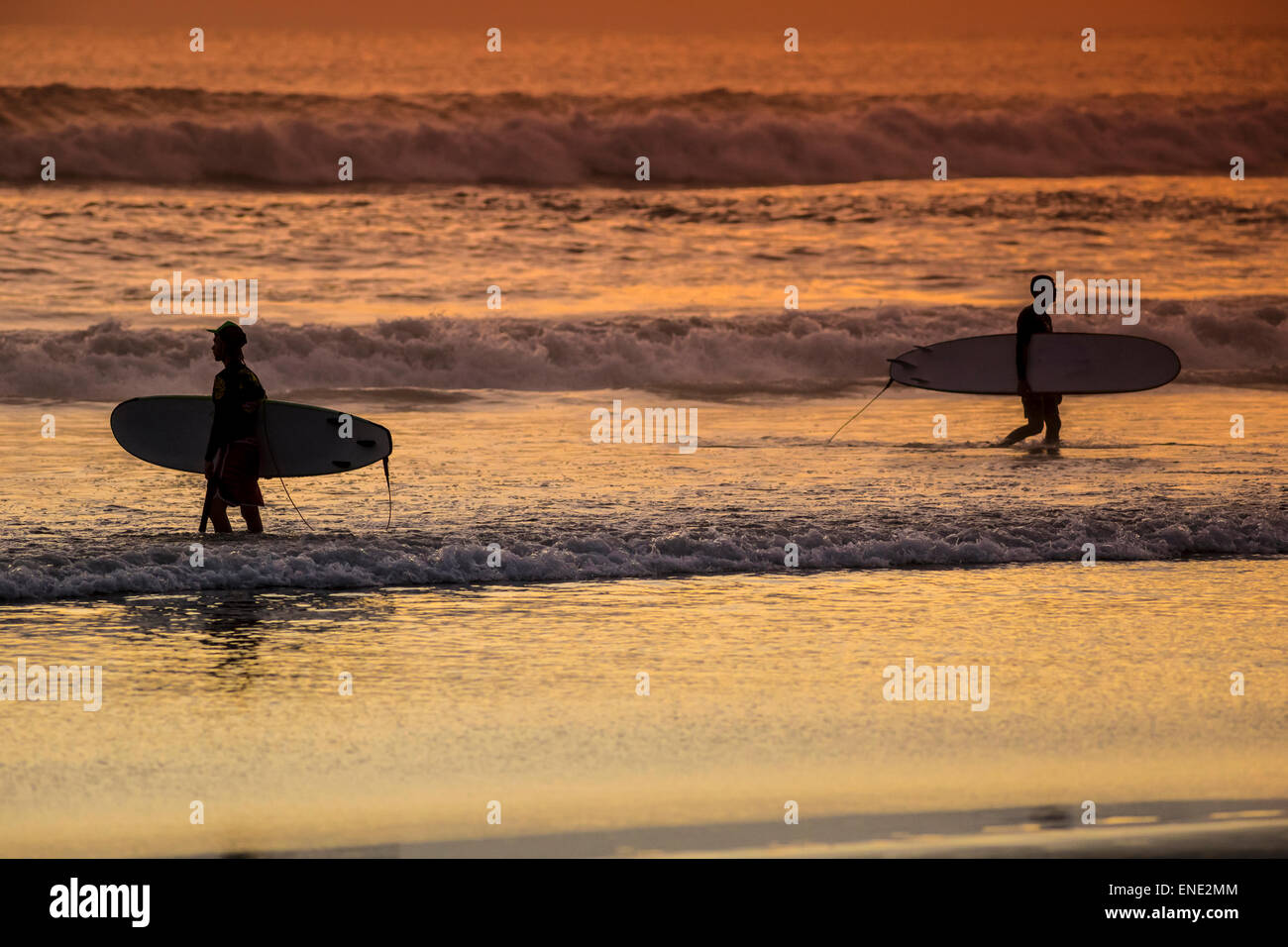 Surfer at sunset Stock Photo - Alamy