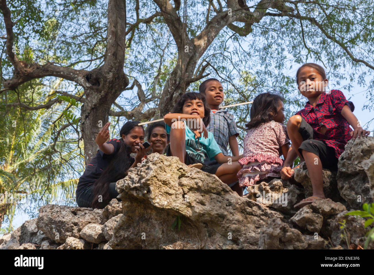 Children sitting on rocks as they are having recreational time in ...