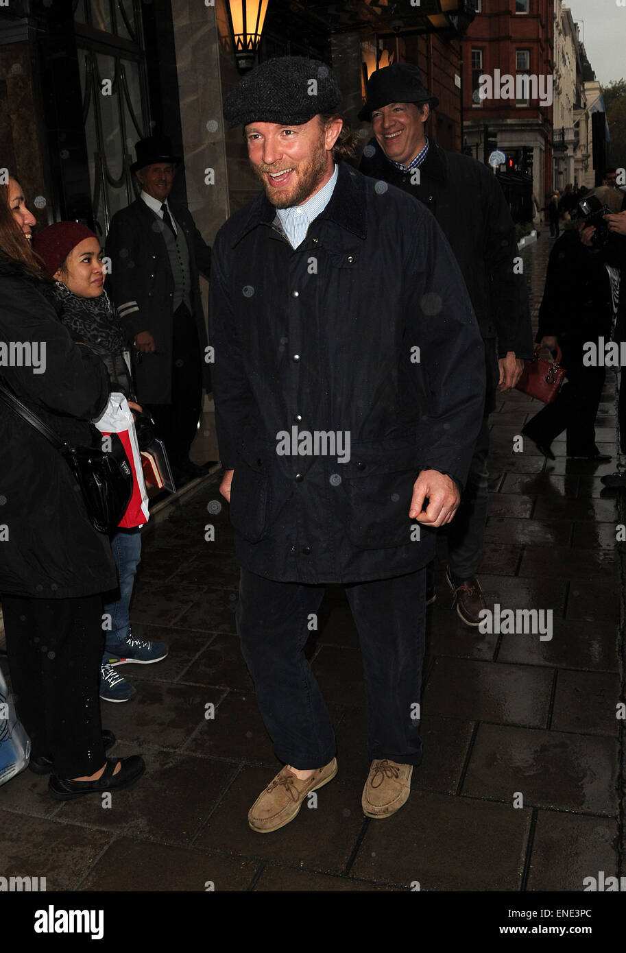 An unshaven Guy Ritchie leaves Claridge's wearing a wax jacket and flat ...
