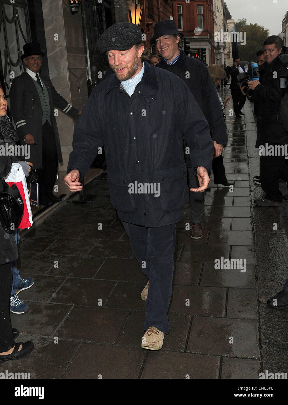 An unshaven Guy Ritchie leaves Claridge's wearing a wax jacket and flat ...