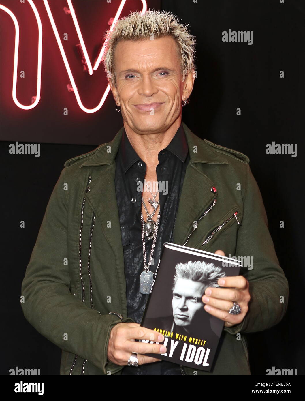 Punk rock star Billy Idol signs copies of his autobiography 'Dancing ...