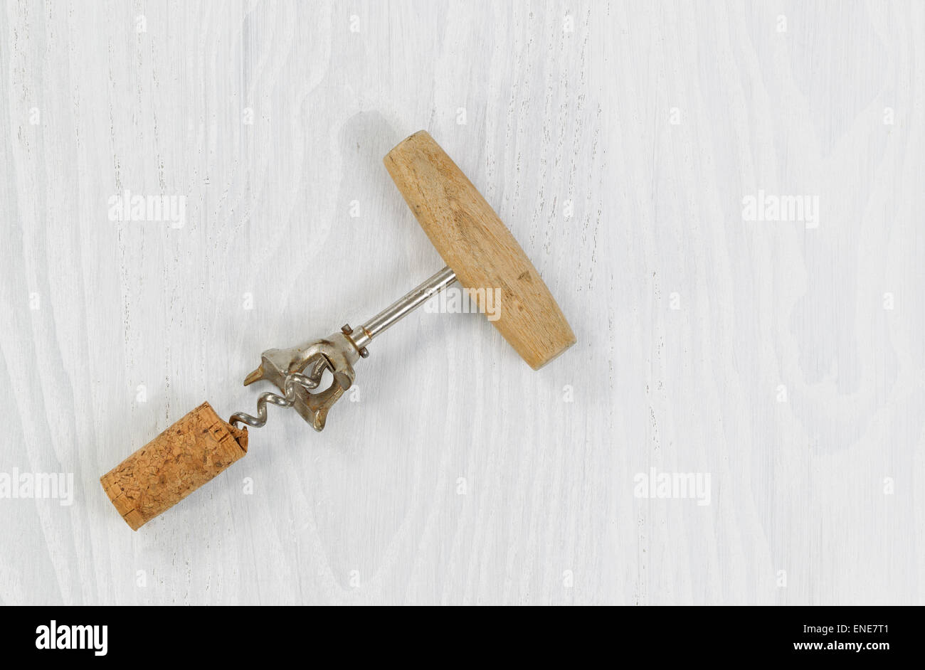 Top view of an antique corkscrew with cork attached on white wood Stock ...