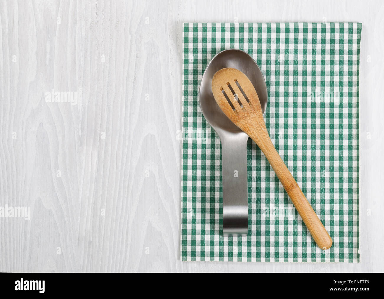 Traditional wooden spoon in stainless steel spoon rest with striped ...