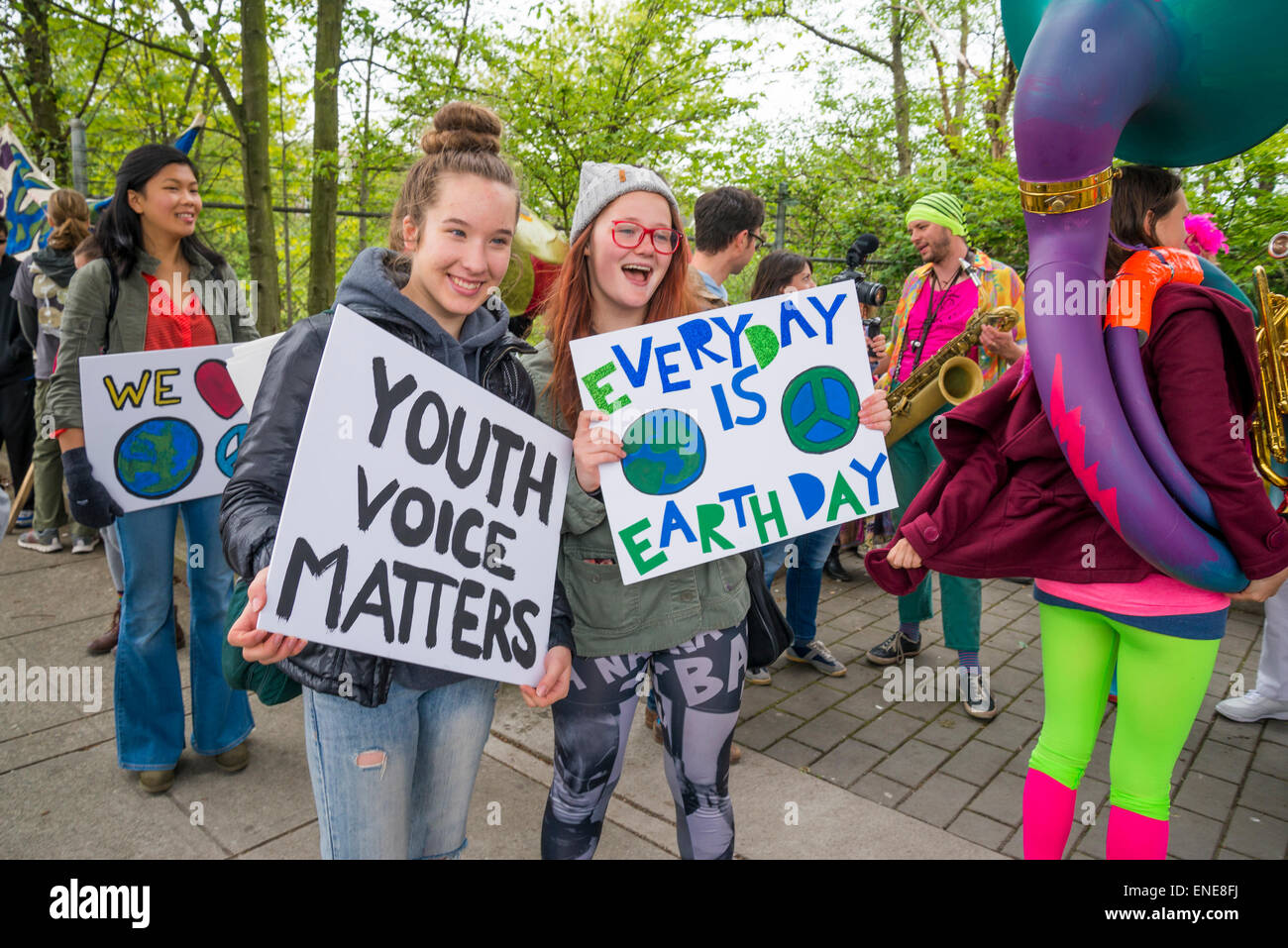Young women with signs. 2015 Earth Day Parade and Festival organised by ...