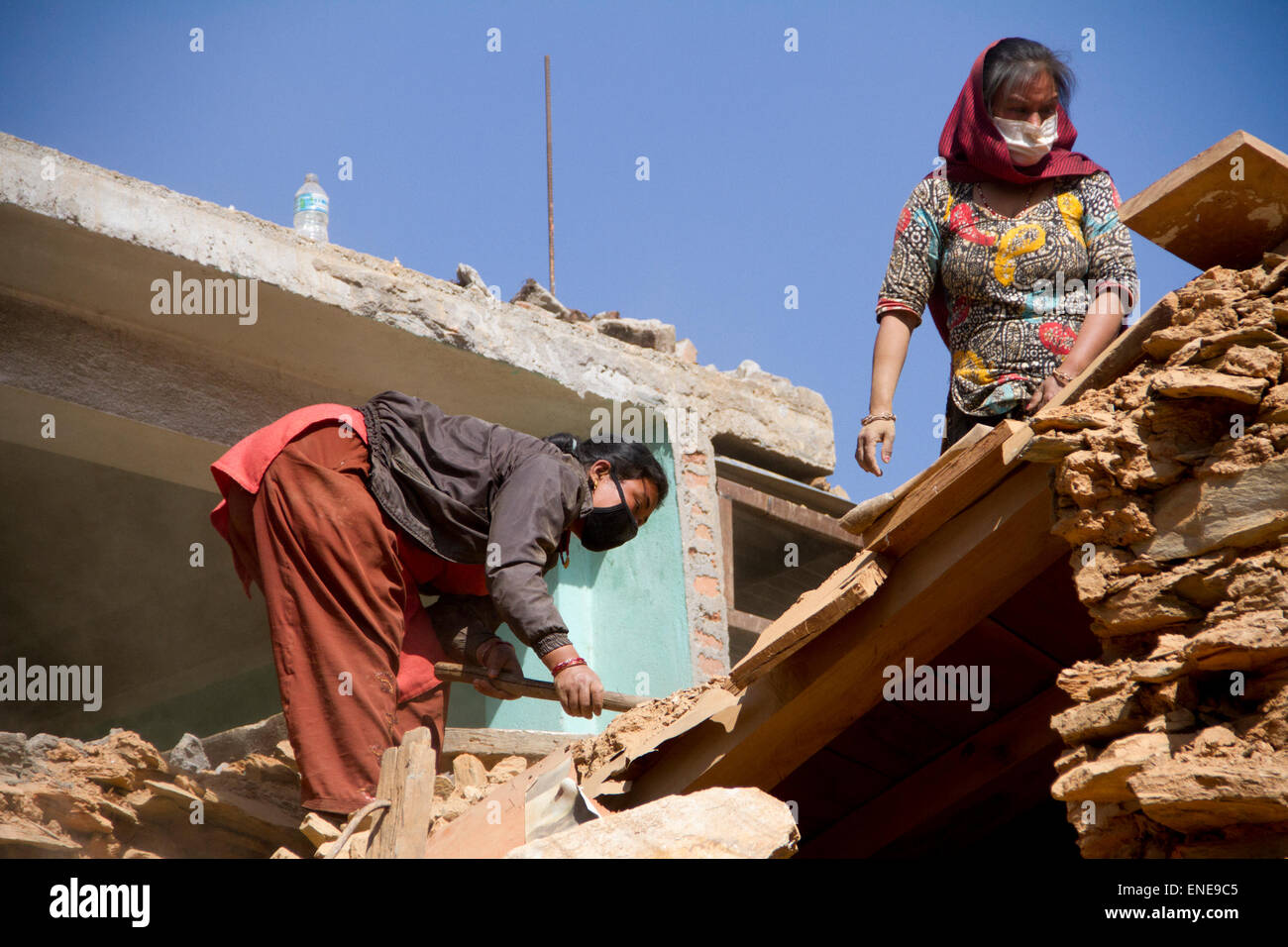 Nepal. 3rd May, 2015. Women dig through a destroyed building in ...