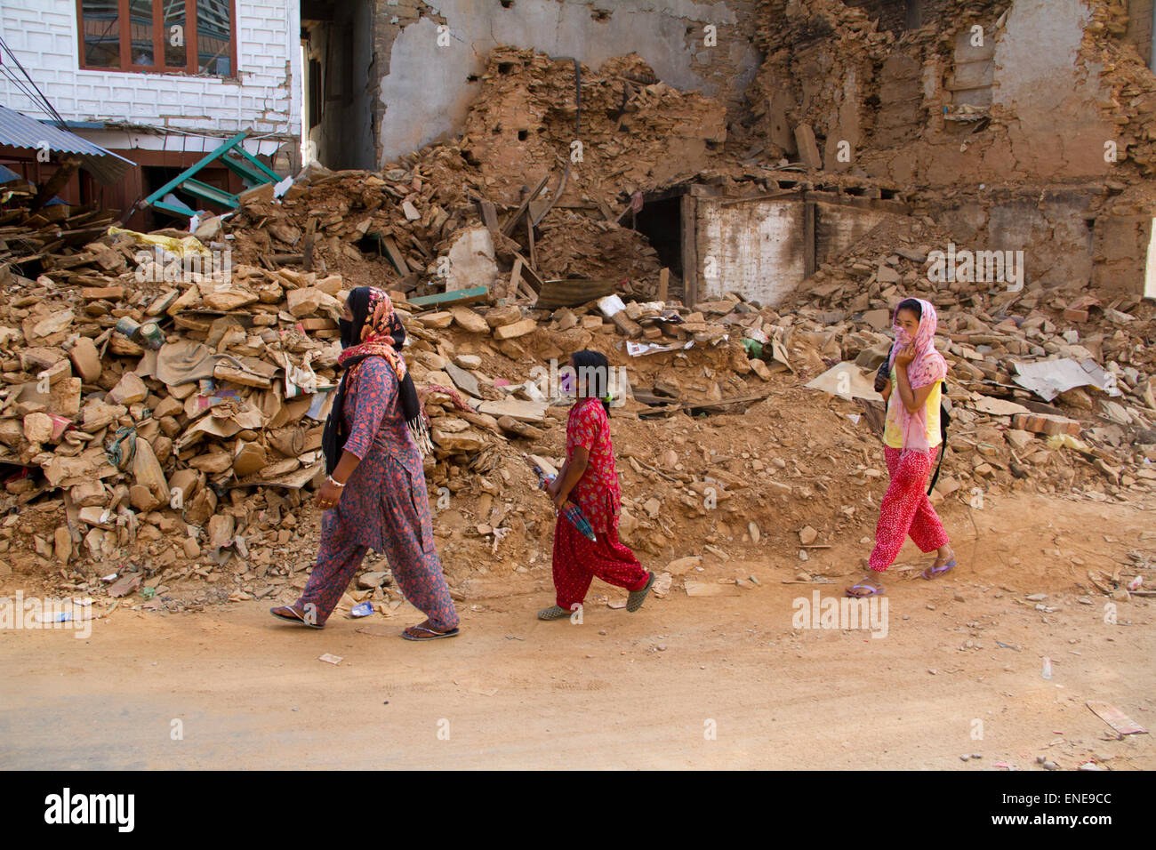 Nepal. 3rd May, 2015. People walk past destroyed buildings in Chautara ...