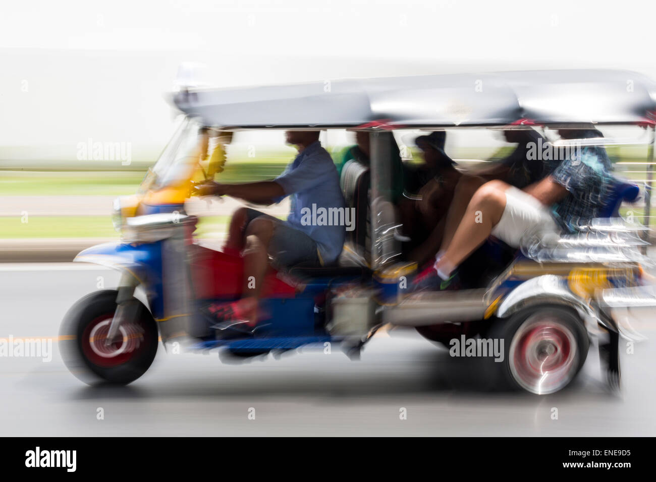Tuk-tuk with passengers at speed in street in Bangkok, Thailand, Asia ...
