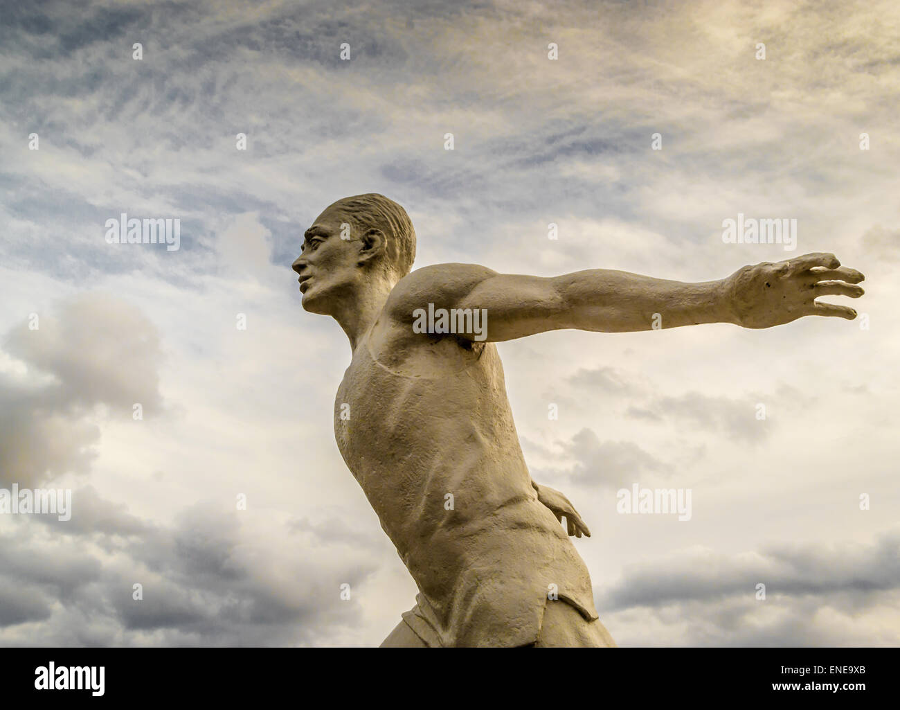 White stone statue of a man running in the clouds Stock Photo - Alamy