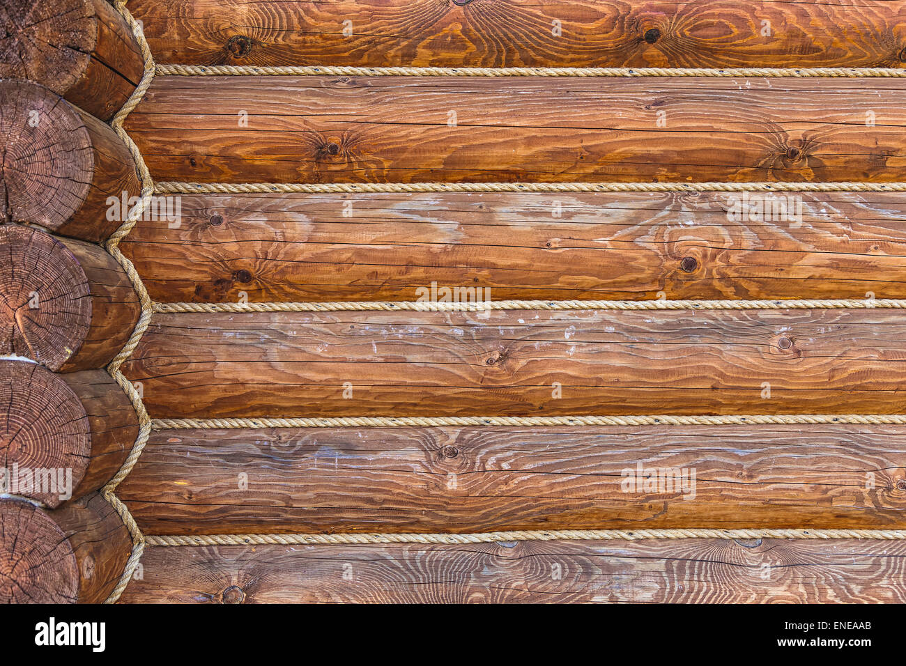 Wooden logs wall with rope of rural house background Stock Photo - Alamy