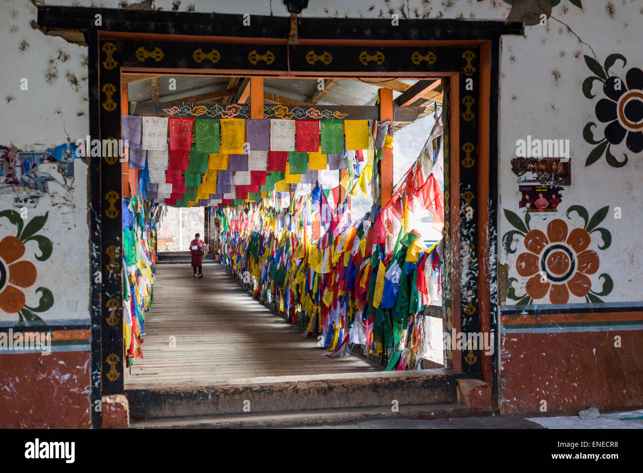 One person on covered bridge by market with prayer flags, Thimphu ...