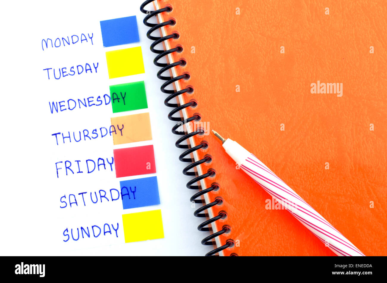 orange notebook red pen and post it monday to sunday Stock Photo - Alamy