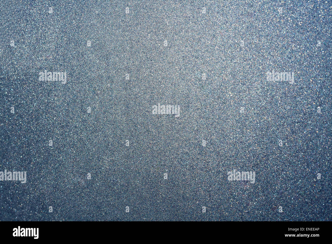 Abstract glittering silver and blue dust or sand background with blur ...