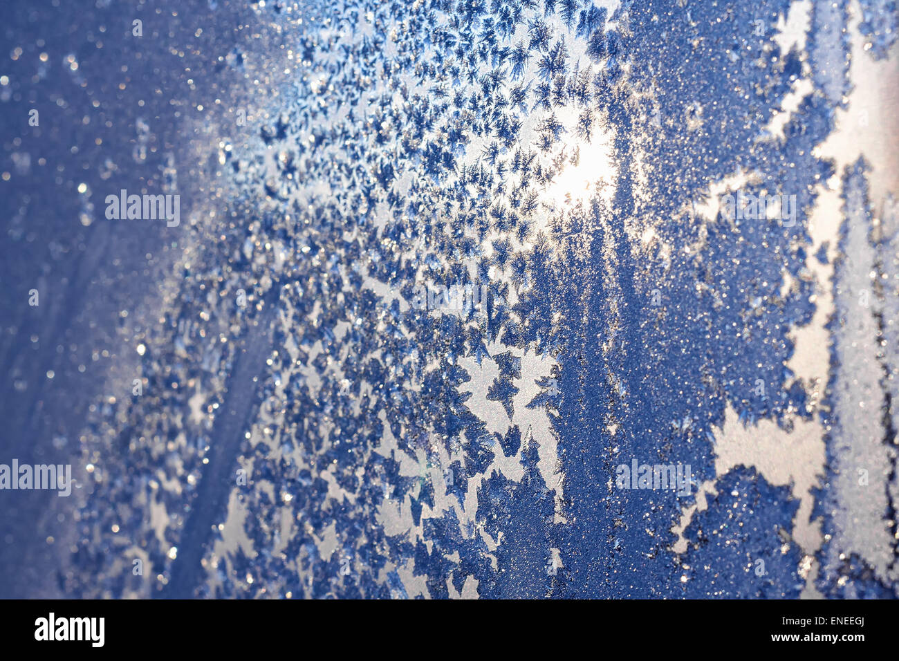 Frozen snowflakes and frost over the sun on frozen Christmas winter ...