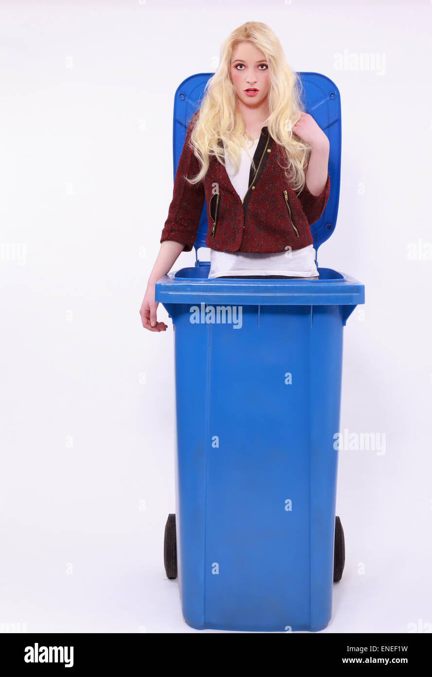 Young woman posing in a blue garbage can Stock Photo - Alamy