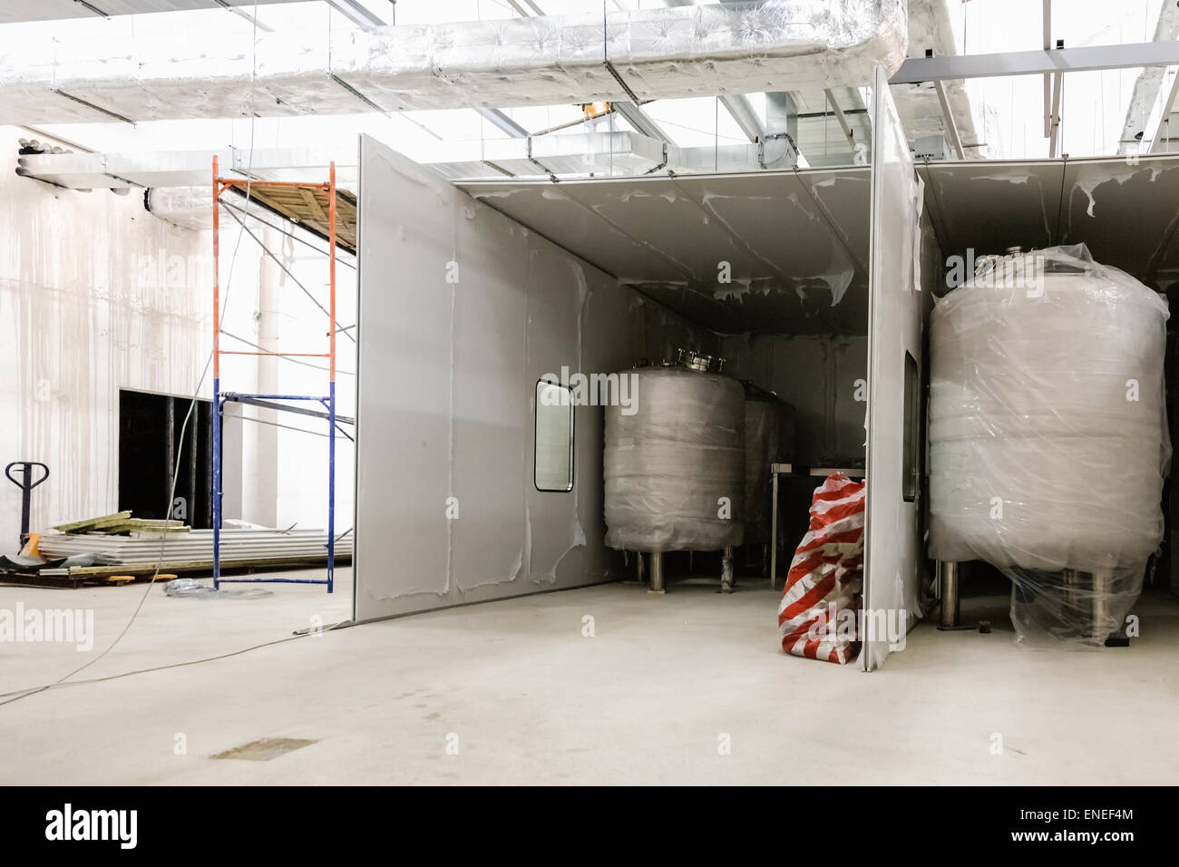 Interior of industrial building with big boiler or reservoir under ...