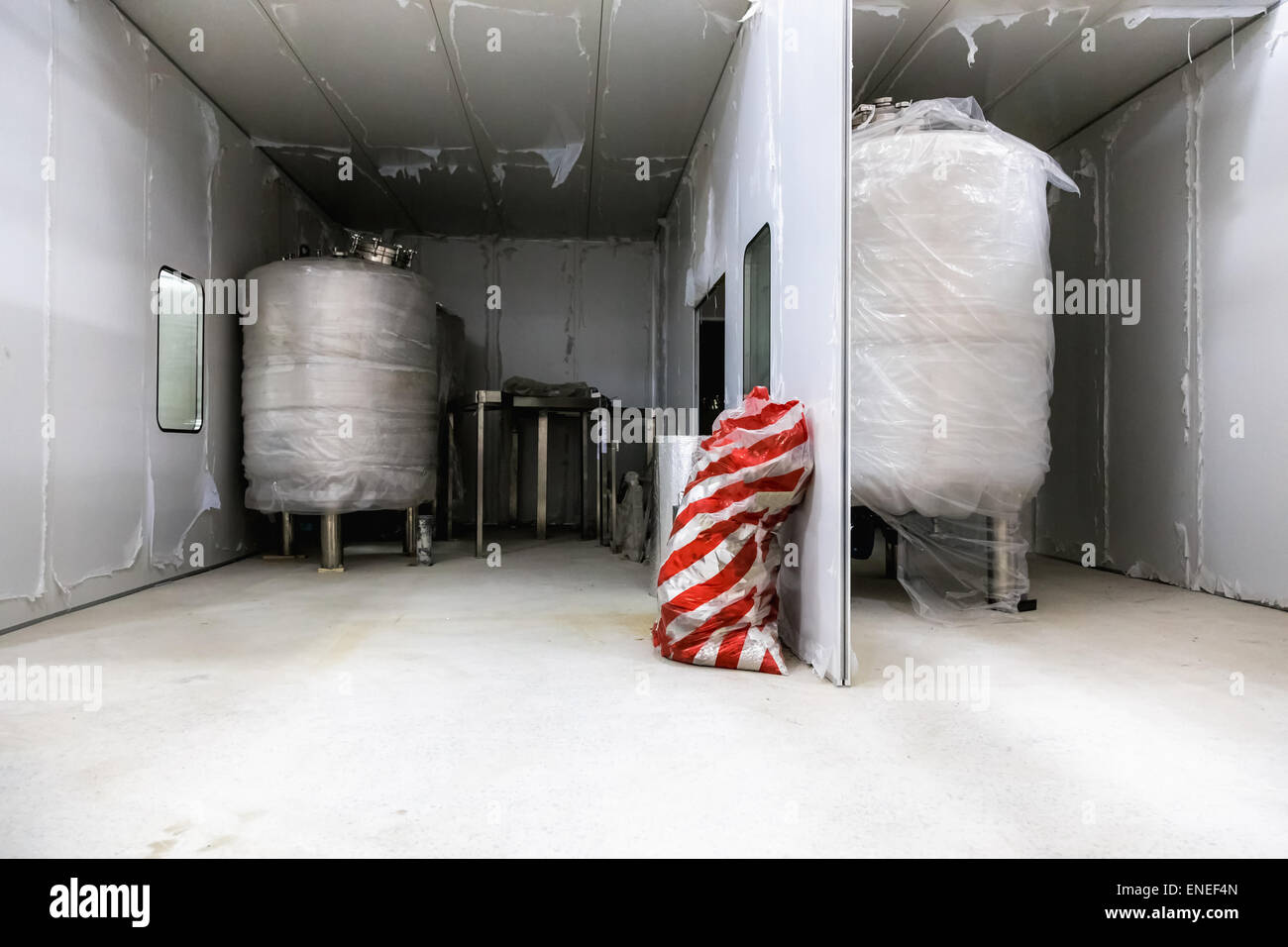 Interior of industrial building with big boiler or reservoir under ...