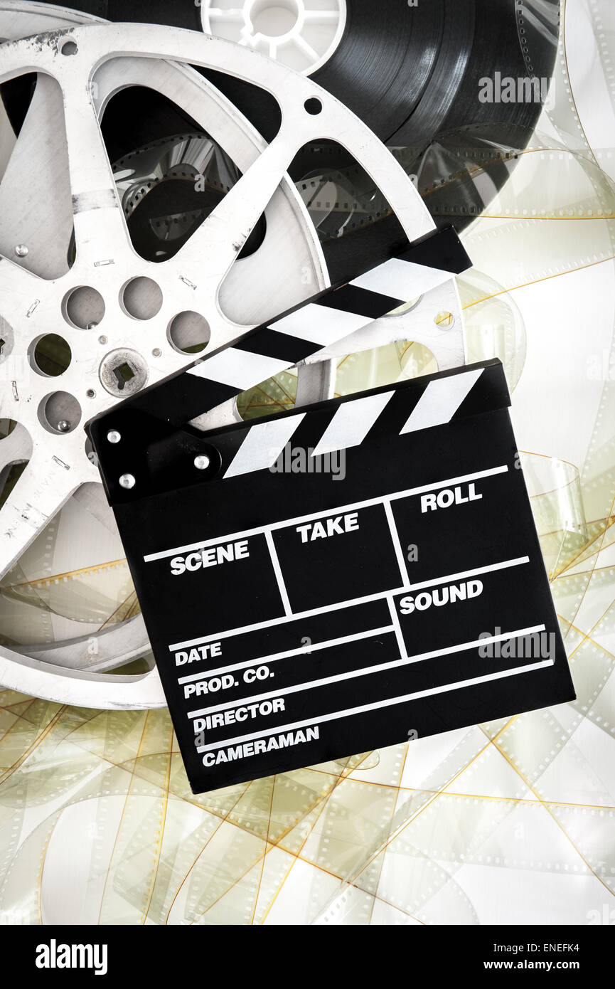 Movie clapper on 35 mm cinema reels unrolled filmstrip on white ...