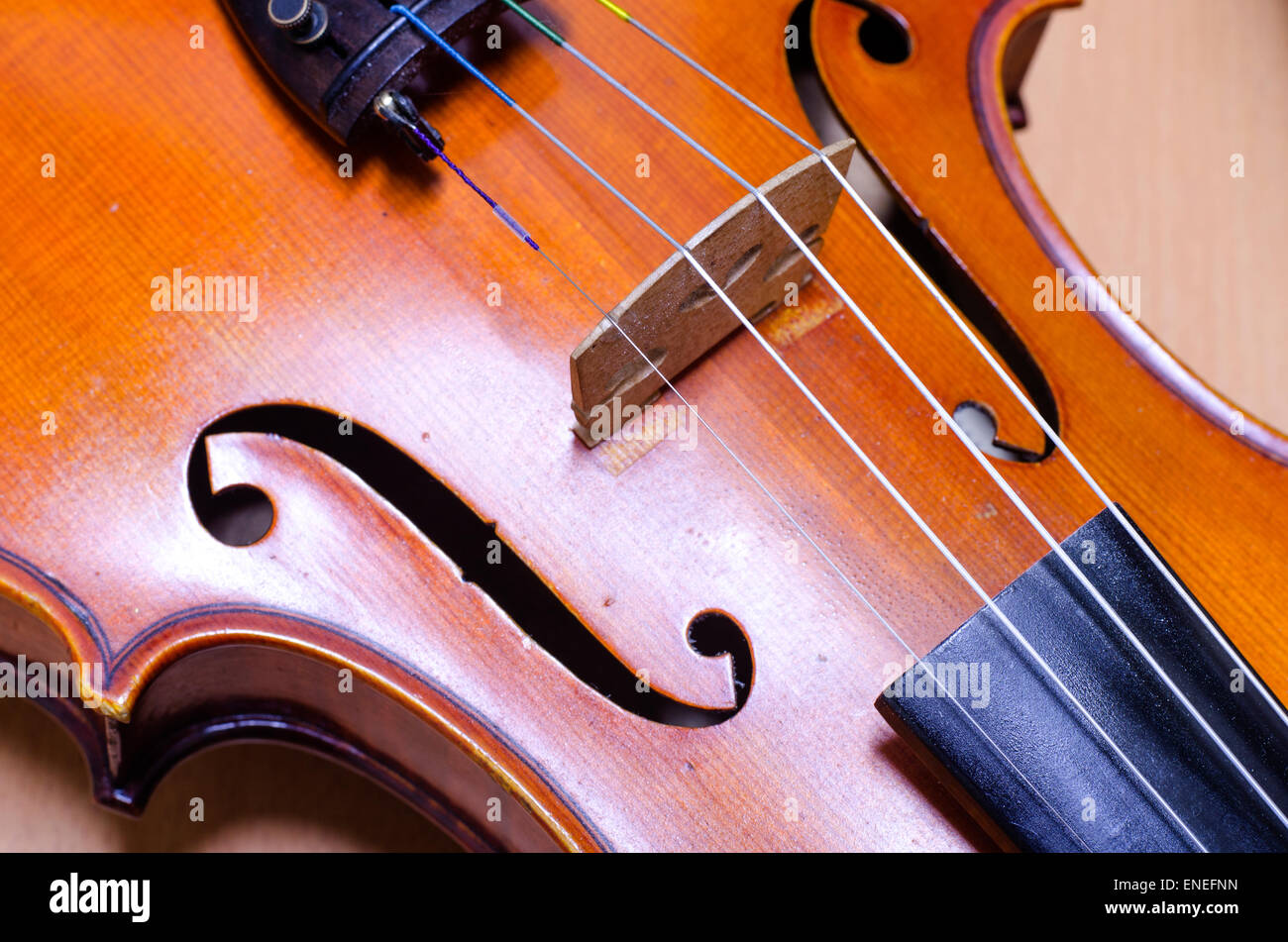 single soft brown violin with brown wallpaper Stock Photo - Alamy