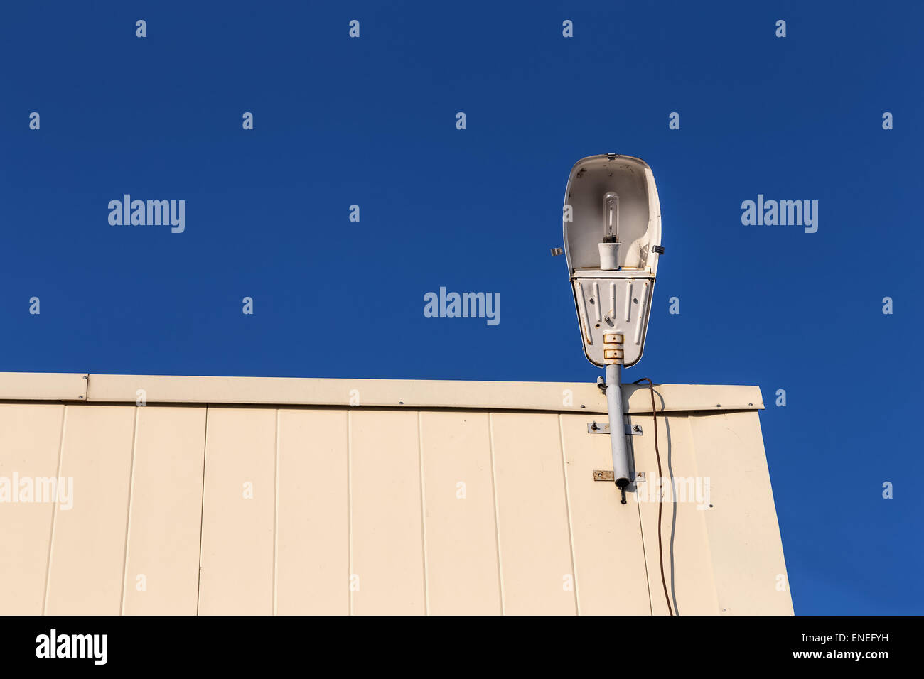 Old vintage lamp on rooftop against blue sky background Stock Photo - Alamy