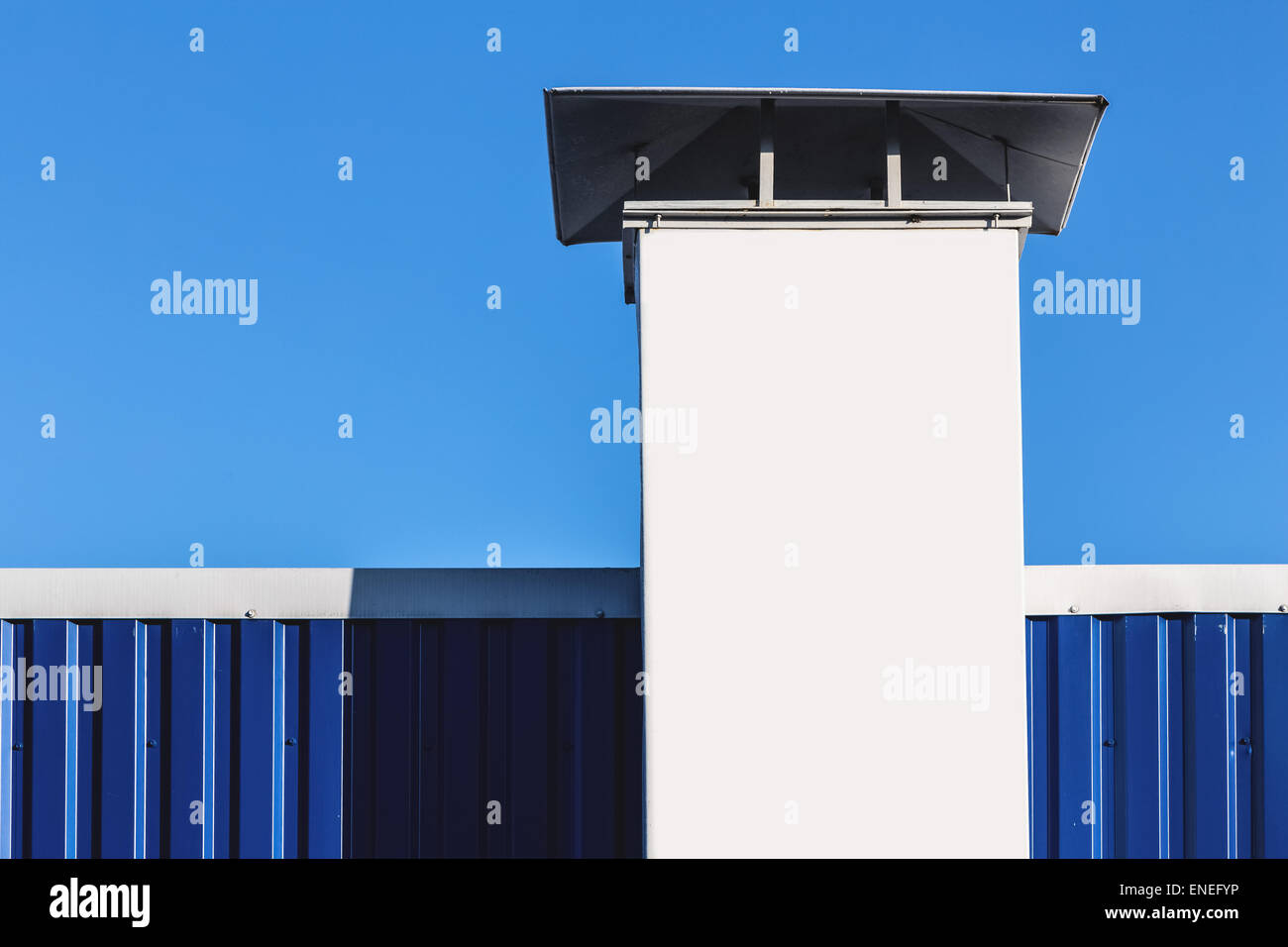 White chimney on building rooftop on blue sky background Stock Photo ...