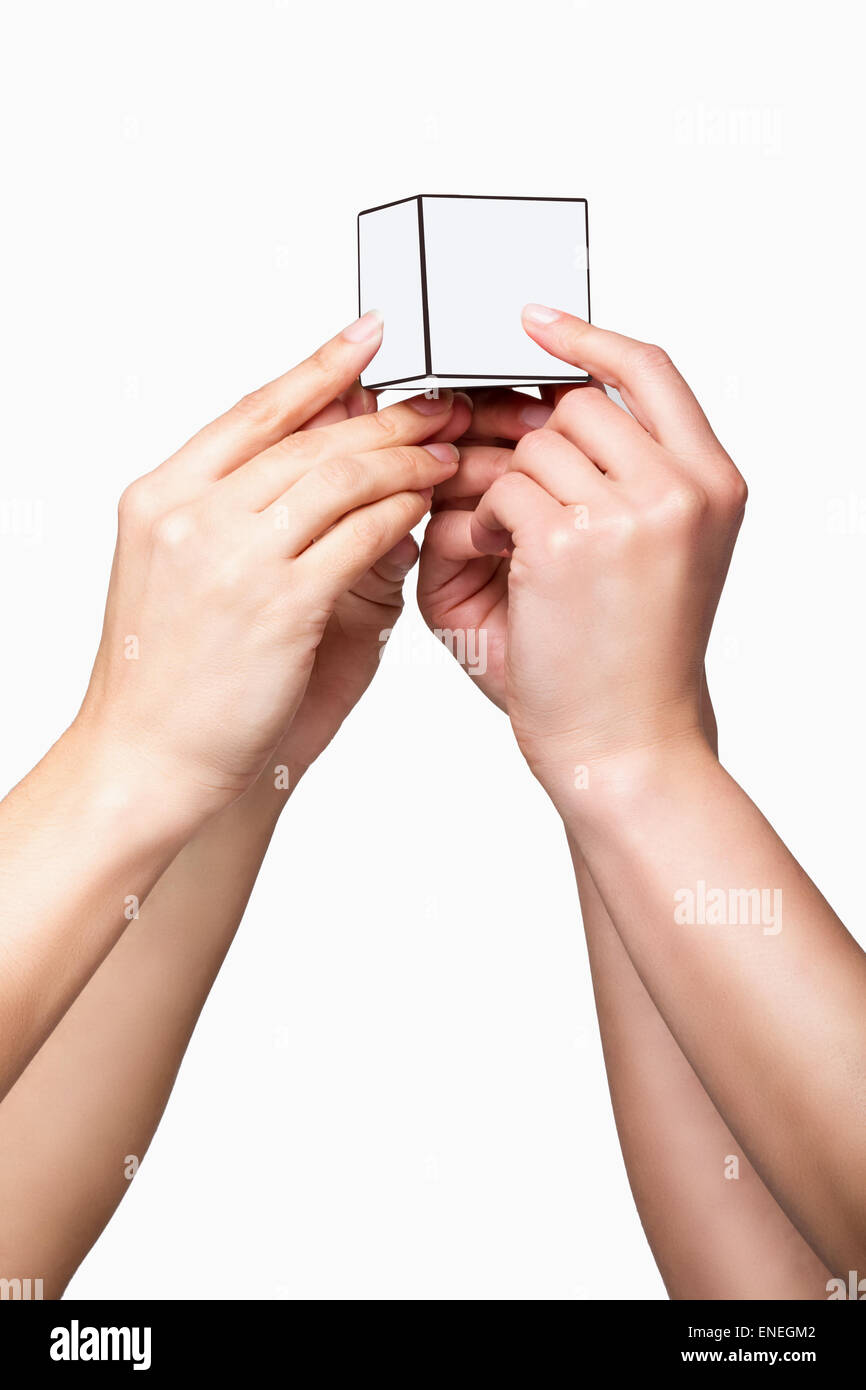 Hands holding white cube on white background Stock Photo - Alamy