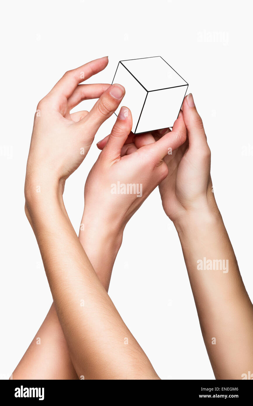 Hands holding white cube on white background Stock Photo - Alamy