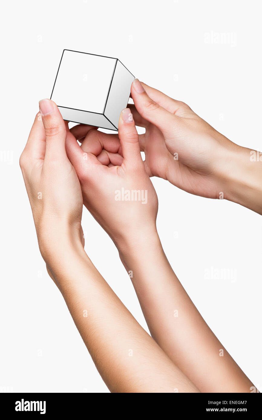 Hands holding white cube on white background Stock Photo - Alamy