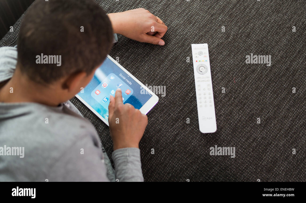 boy using ipad for online social media Stock Photo - Alamy