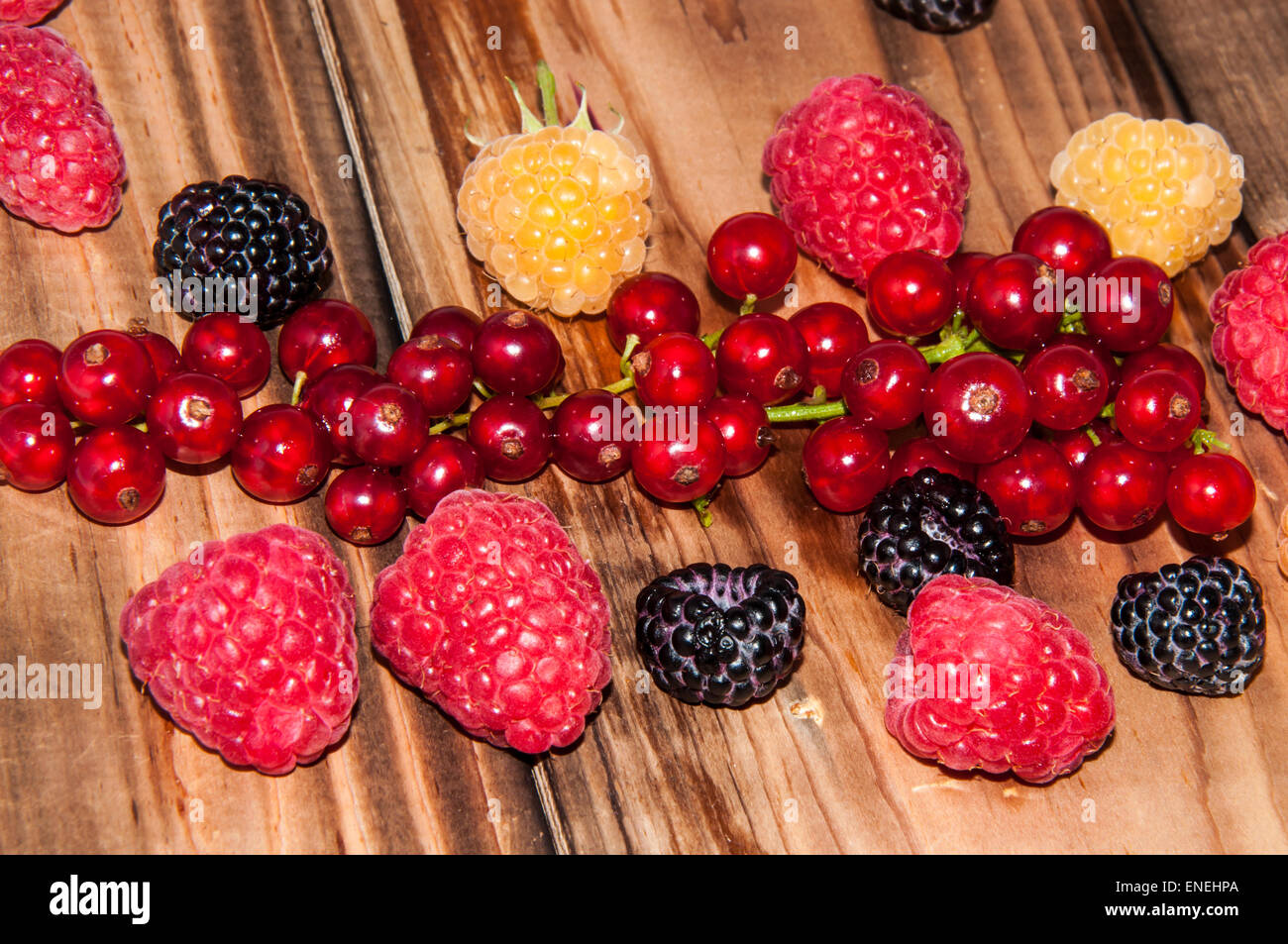 Assorted Berry on the old wooden table top Stock Photo - Alamy