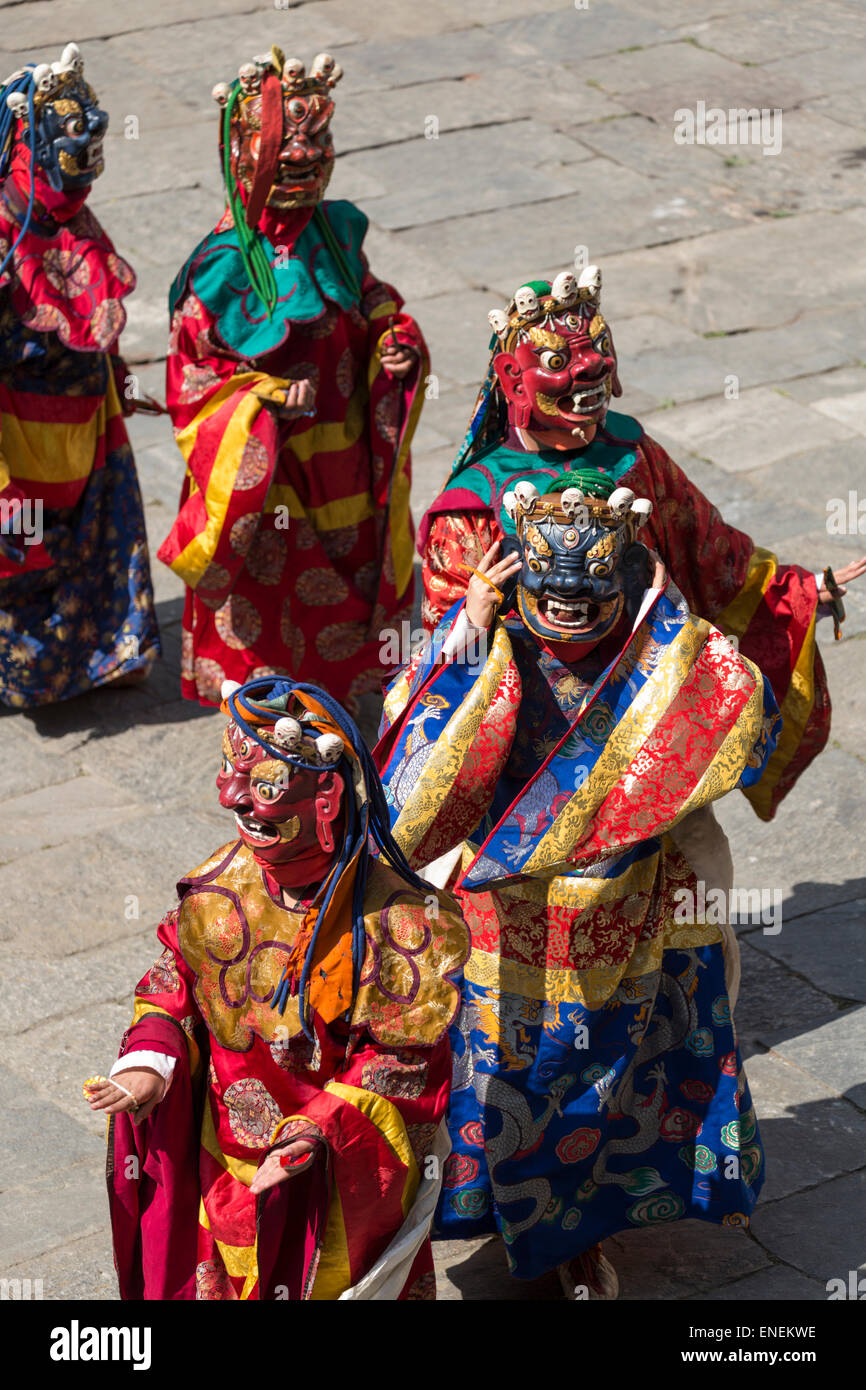 Masked dancers dancing at Drubchen (religious retreat) at Trongsa Dzong, Trongsa, Central Bhutan ...