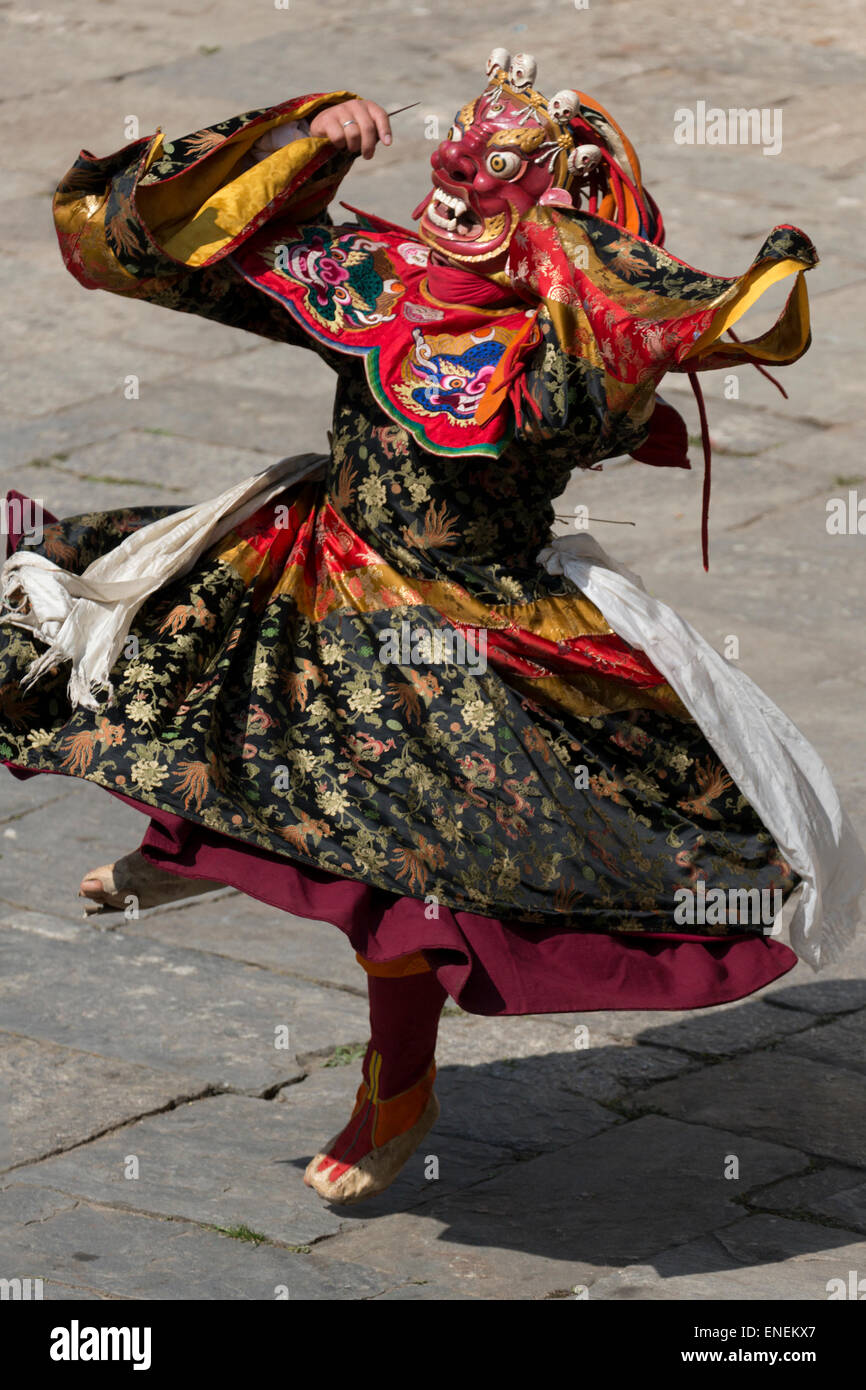 Masked dancers dancing at Drubchen (religious retreat) at Trongsa Dzong, Trongsa, Central Bhutan ...