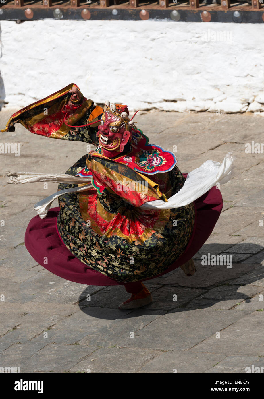 Masked dancers dancing at Drubchen (religious retreat) at Trongsa Dzong, Trongsa, Central Bhutan ...