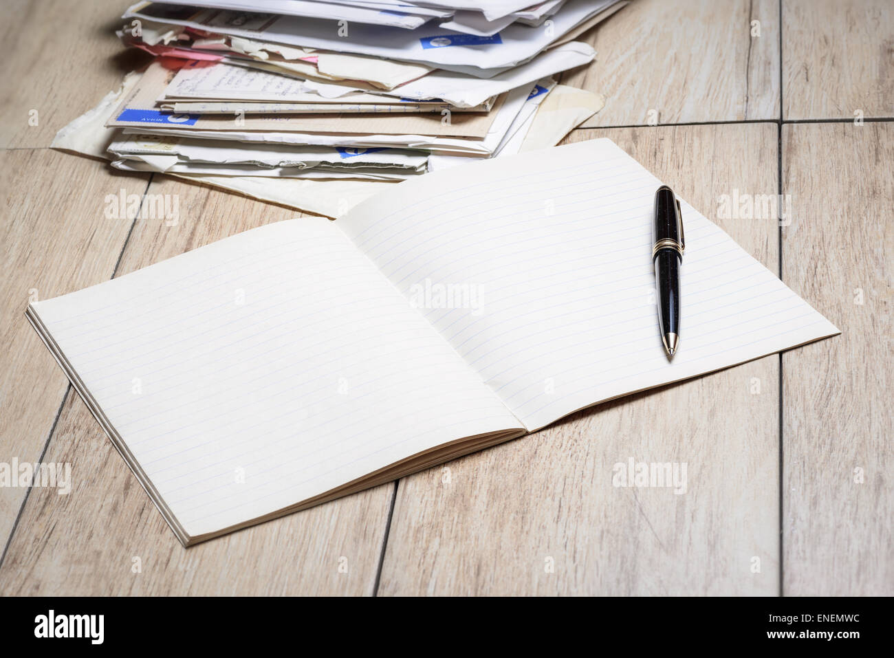 In the picture a copybook with white sheets and a pen with letters in ...