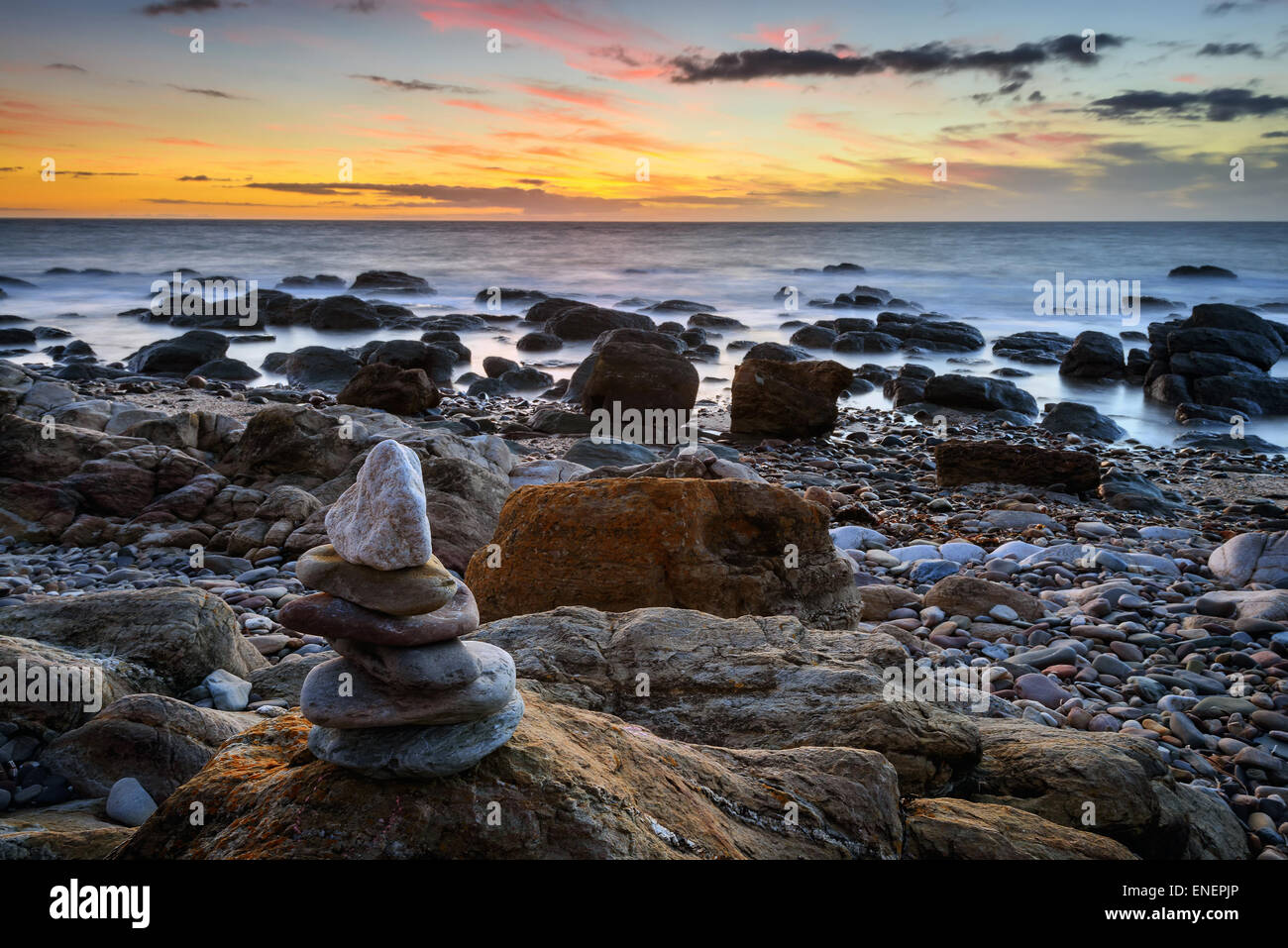 Stone pyramid and sunset at the beach. Long exposure effect Stock Photo ...