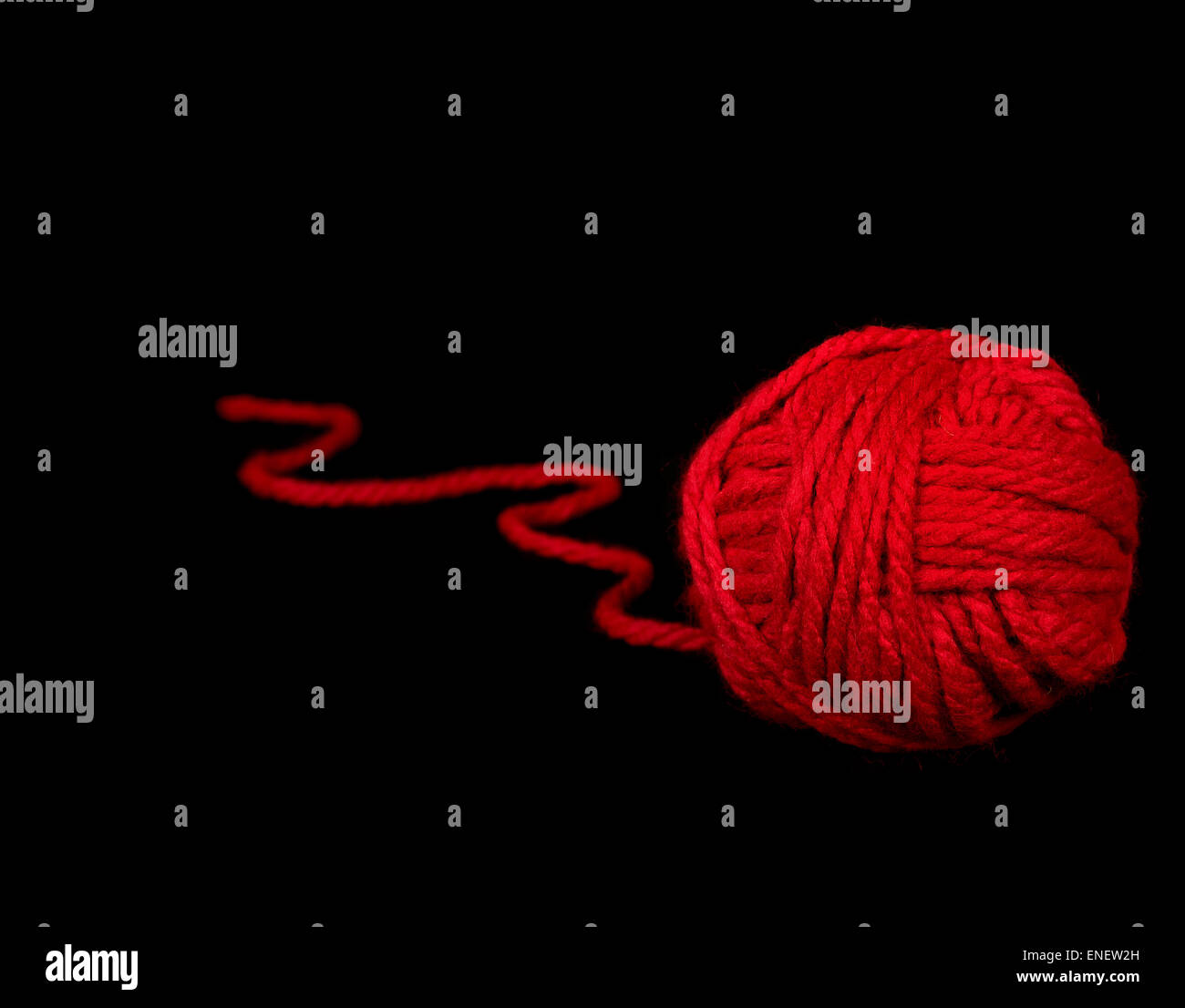 Bright red ball of yarn isolated on black Stock Photo - Alamy
