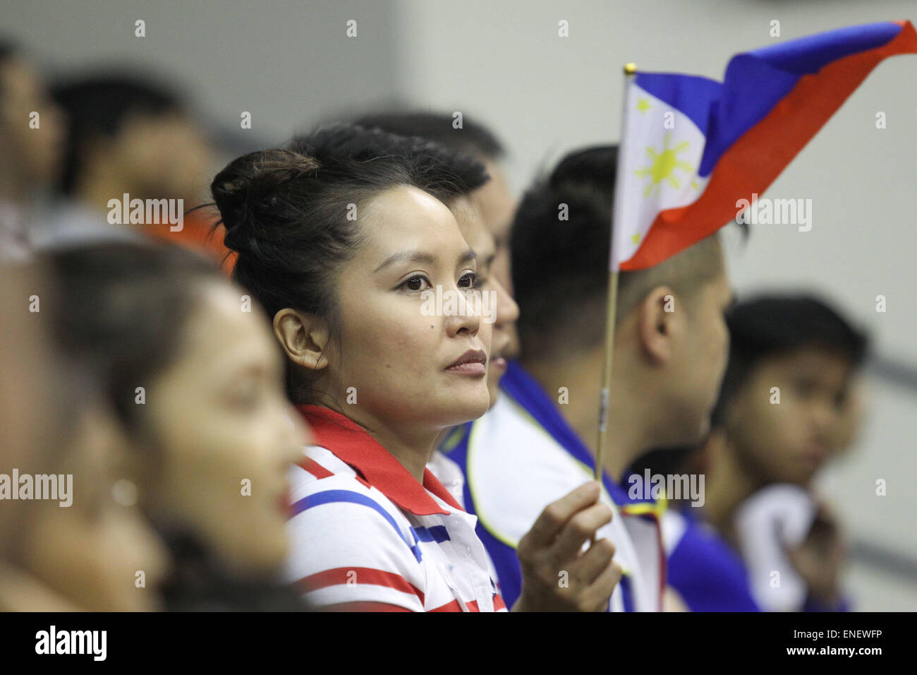 Pasig, Philippines. 4th May, 2015. A fan raises a Philippine flag ...