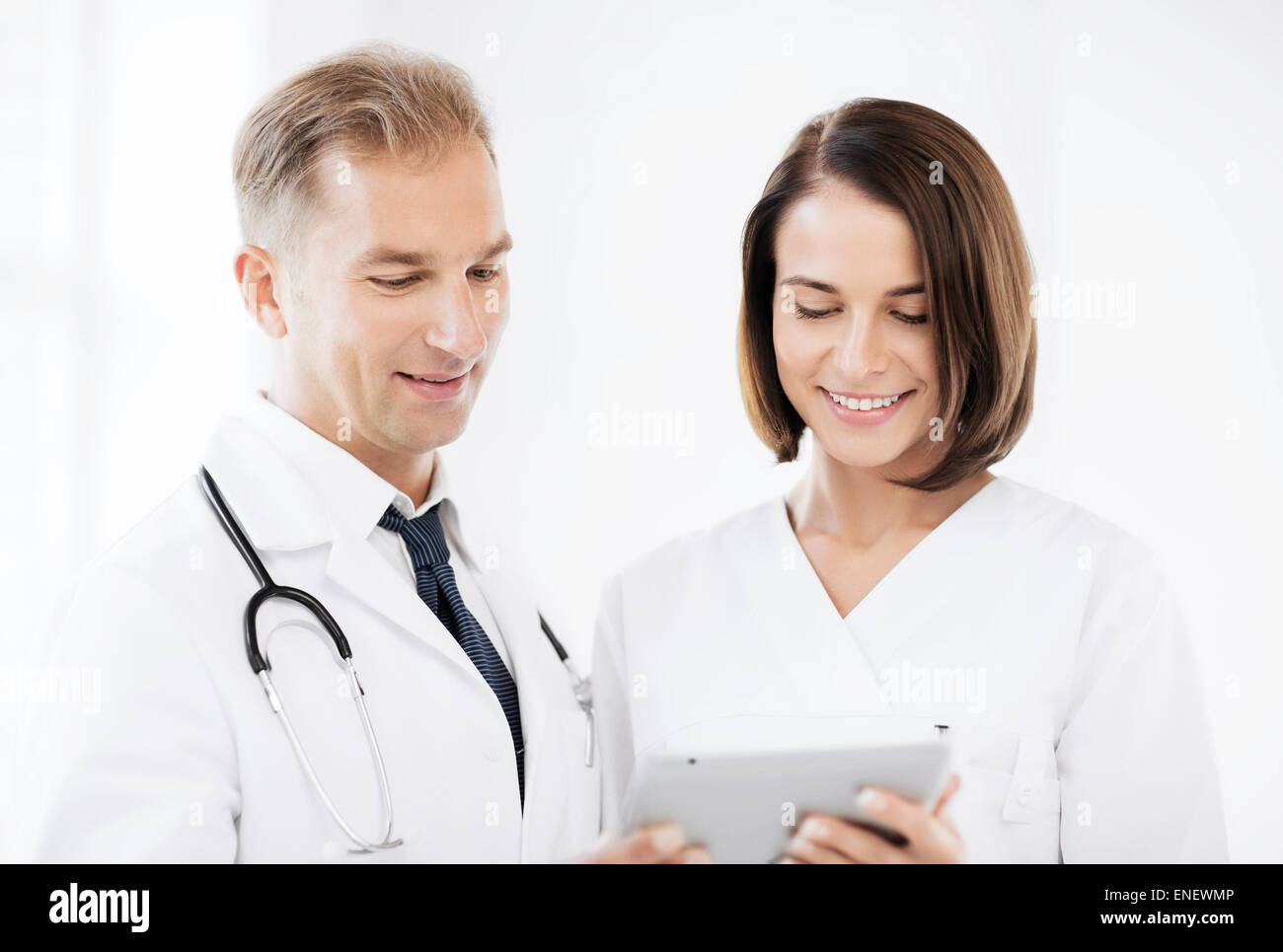 two doctors looking at tablet pc Stock Photo - Alamy