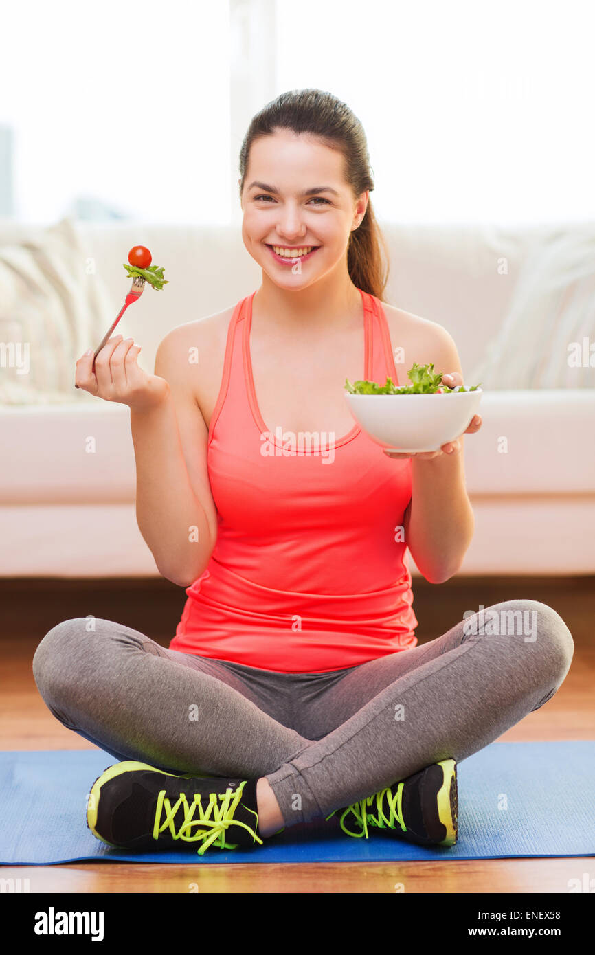 smiling teenage girl with green salad at home Stock Photo - Alamy