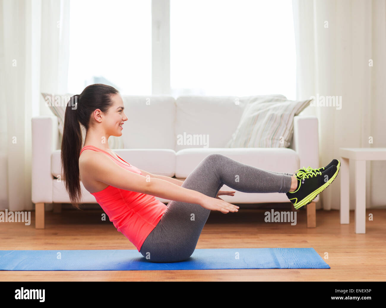 smiling girl doing exercise on floor at home Stock Photo - Alamy