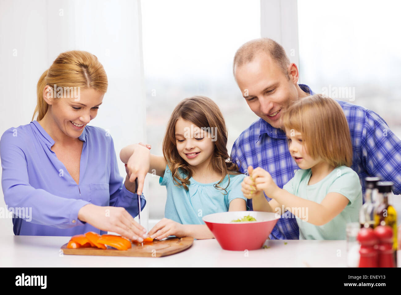 happy family with two kids making dinner at home Stock Photo - Alamy