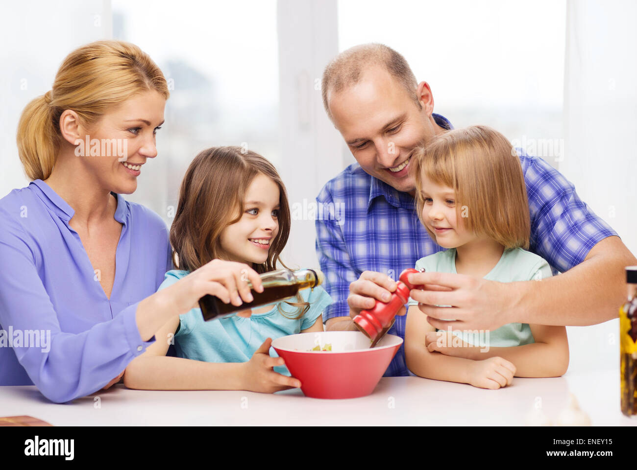 happy family with two kids making dinner at home Stock Photo - Alamy