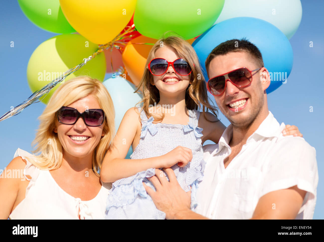 happy family with colorful balloons outdoors Stock Photo - Alamy