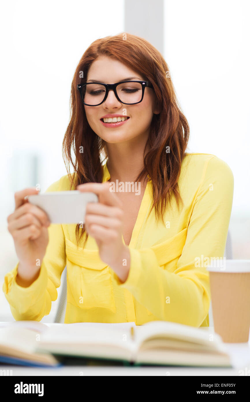 smiling student girl with smartphone at school Stock Photo - Alamy
