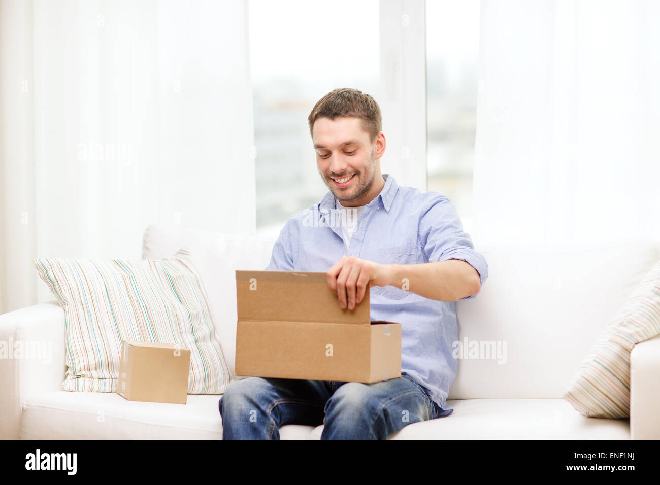 man with cardboard boxes at home Stock Photo - Alamy