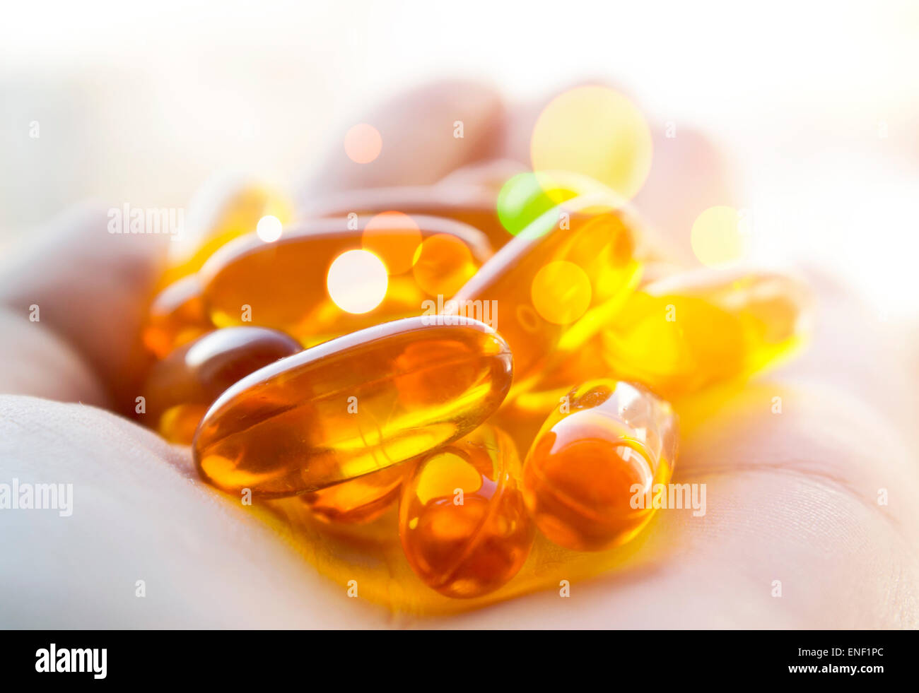 Cod liver oil pills in hand. Magic healing pills Stock Photo - Alamy