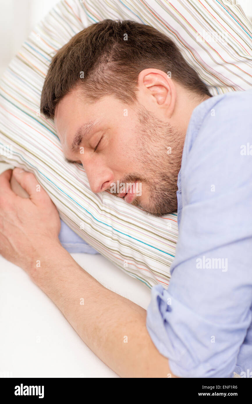 Young guy sleeping on sofa hi-res stock photography and images - Alamy